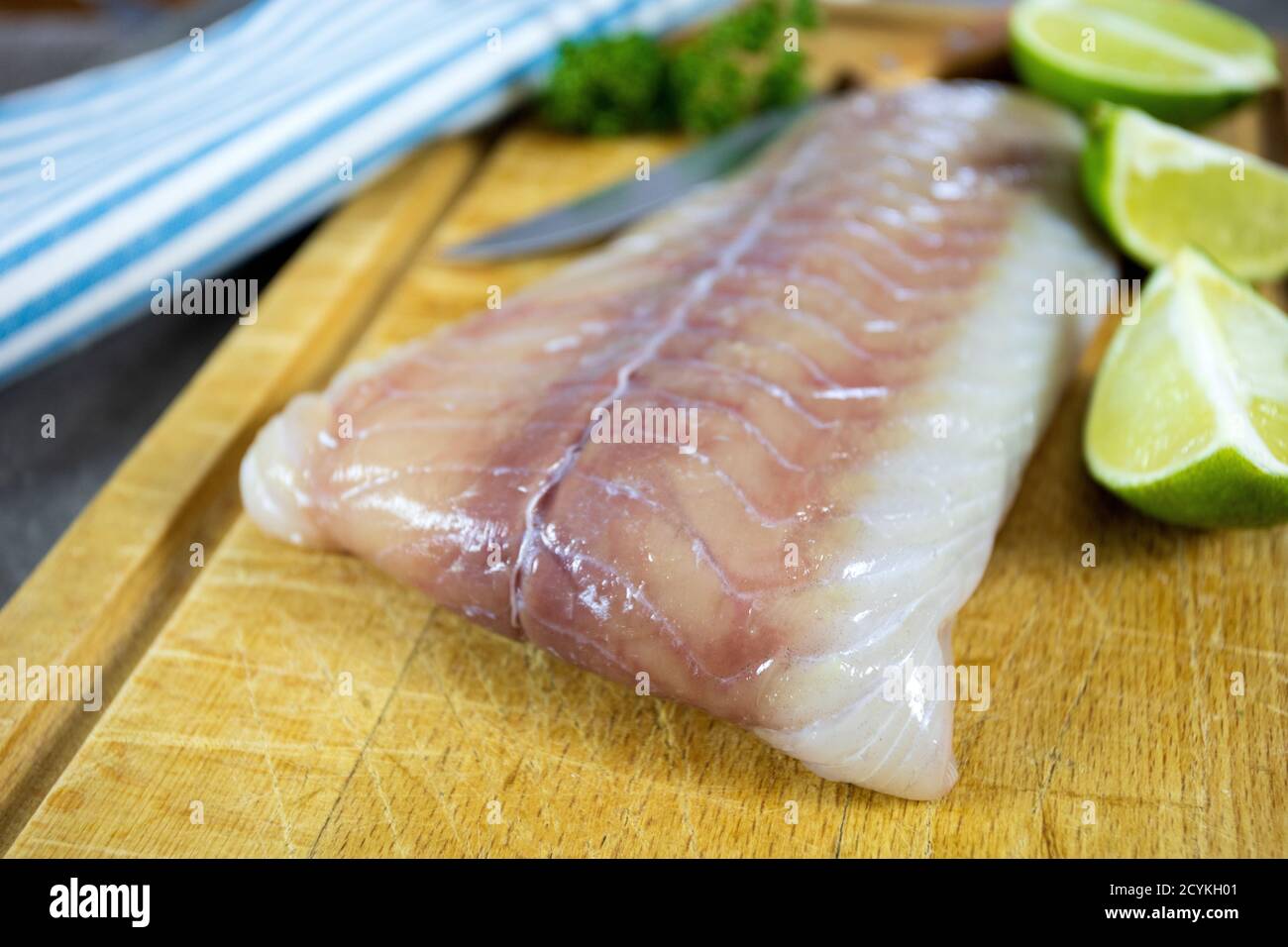 raw fish fillet (saithe) on a cutting board Stock Photo - Alamy