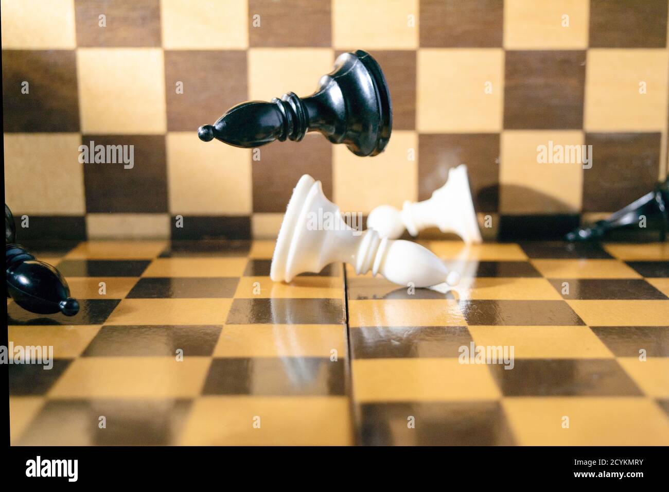 concept, chess pieces falling on the chessboard Stock Photo - Alamy