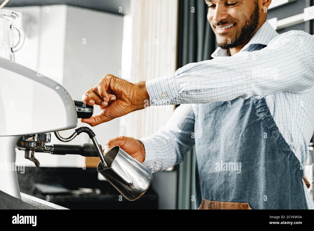 African american man barista preparing coffee on professional coffee ...