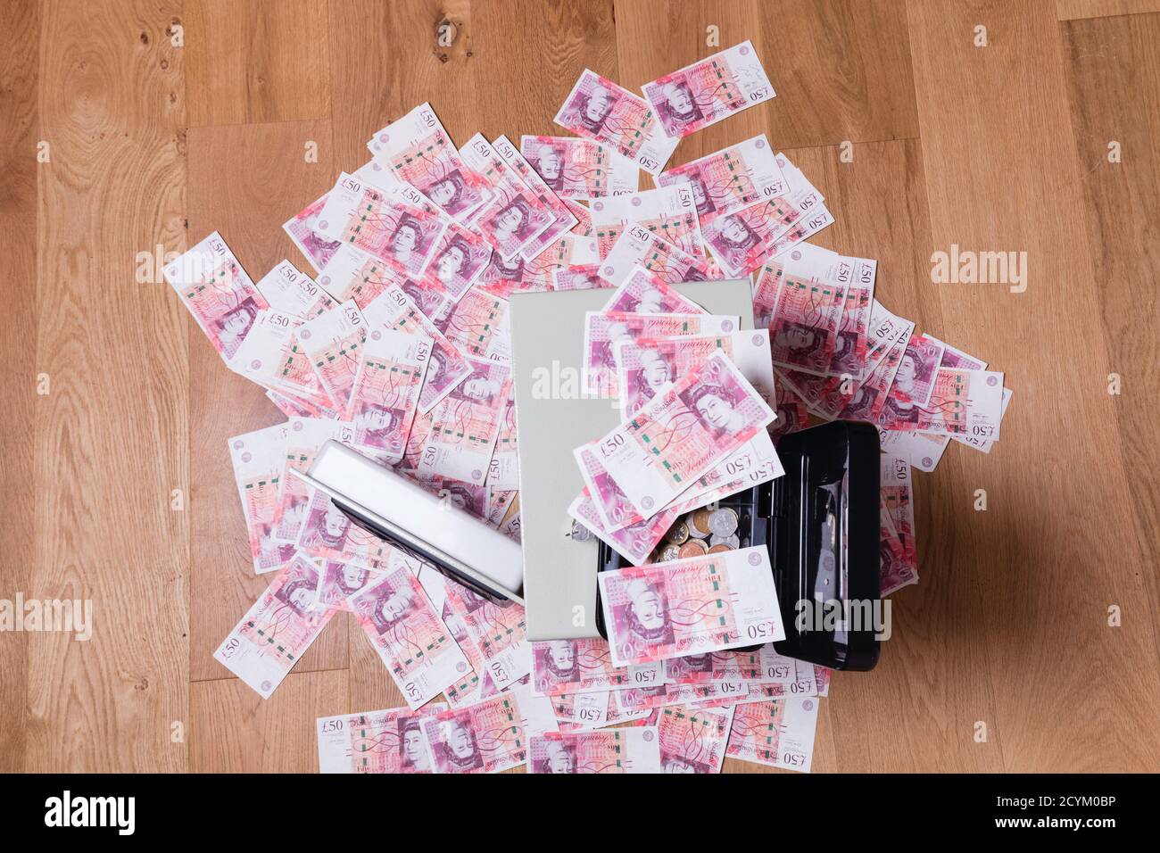 Home safe and cash box overflowing with money Stock Photo - Alamy
