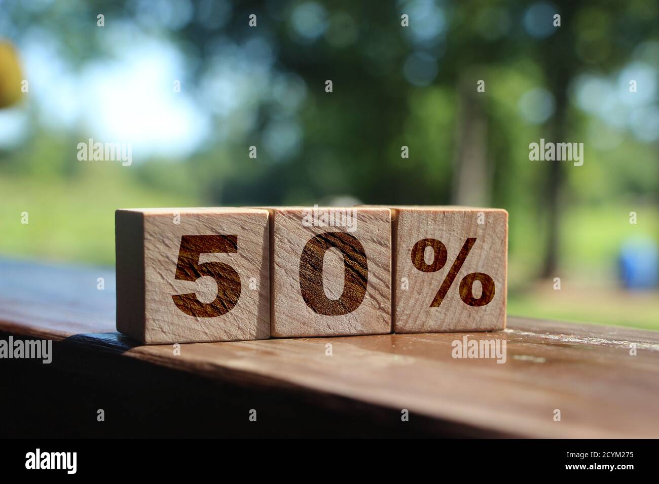 50 percent written on wooden blocks on nature landscape background ...