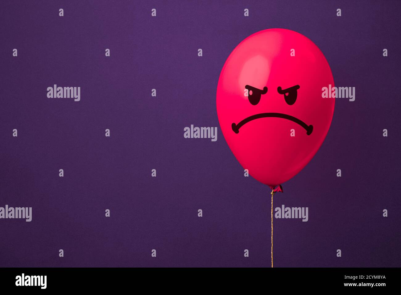 Stock photo of a red balloon with angry face on a purple background ...