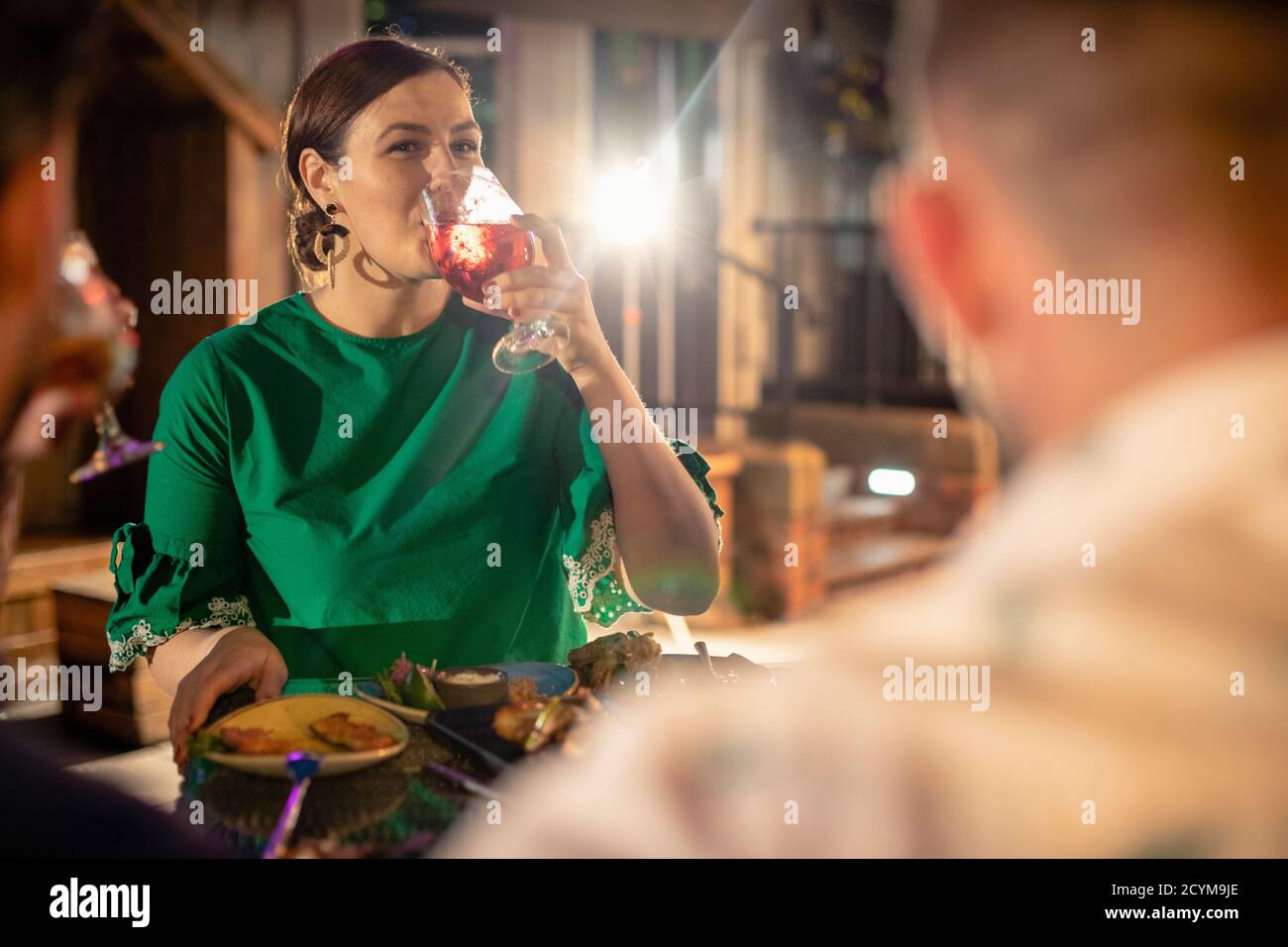 Friends drinking alcohol outdoors at a bar/restaurant, celebrating and ...