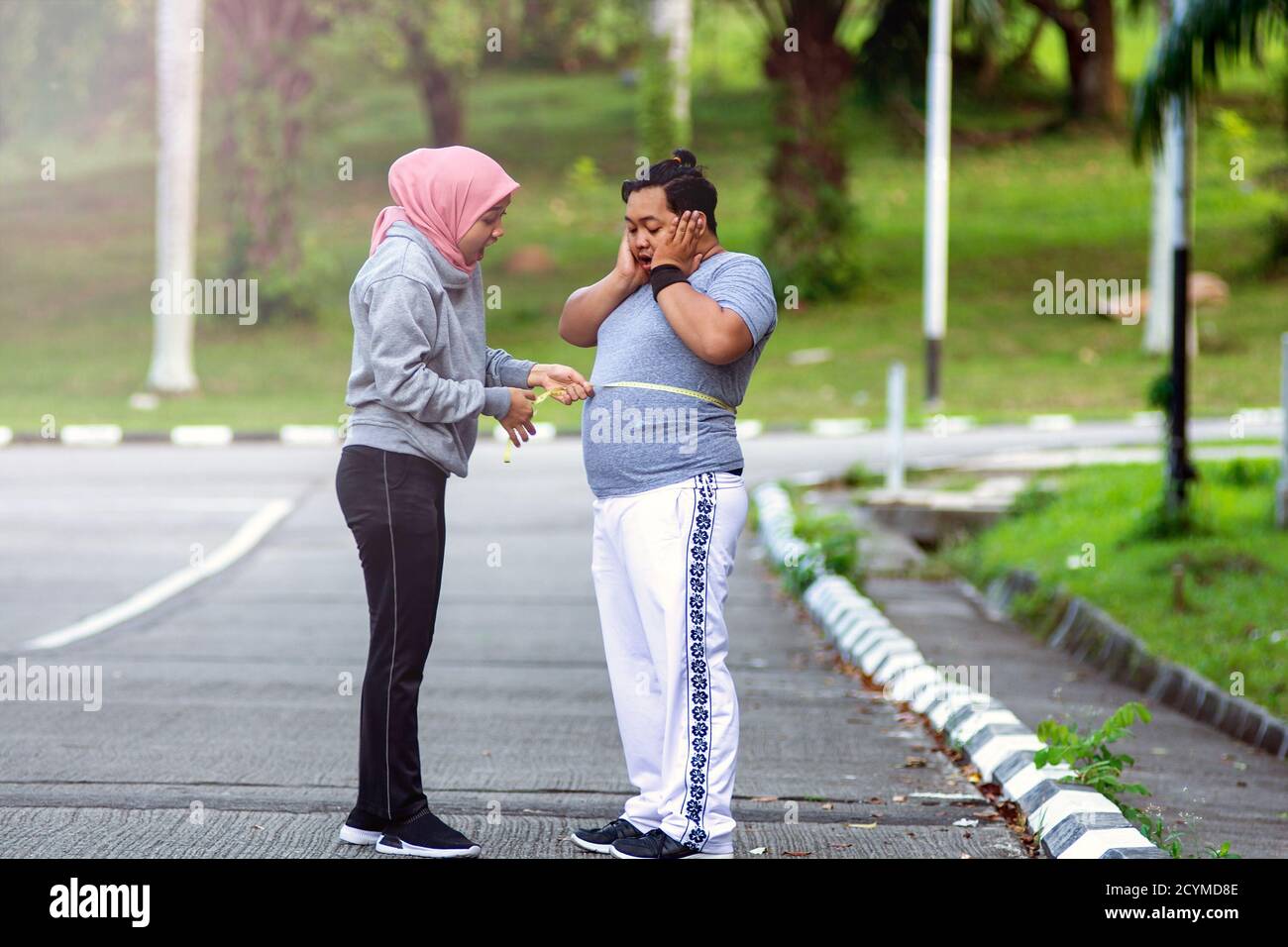 Two people, muslim woman and fat man, proportional and over weight ...