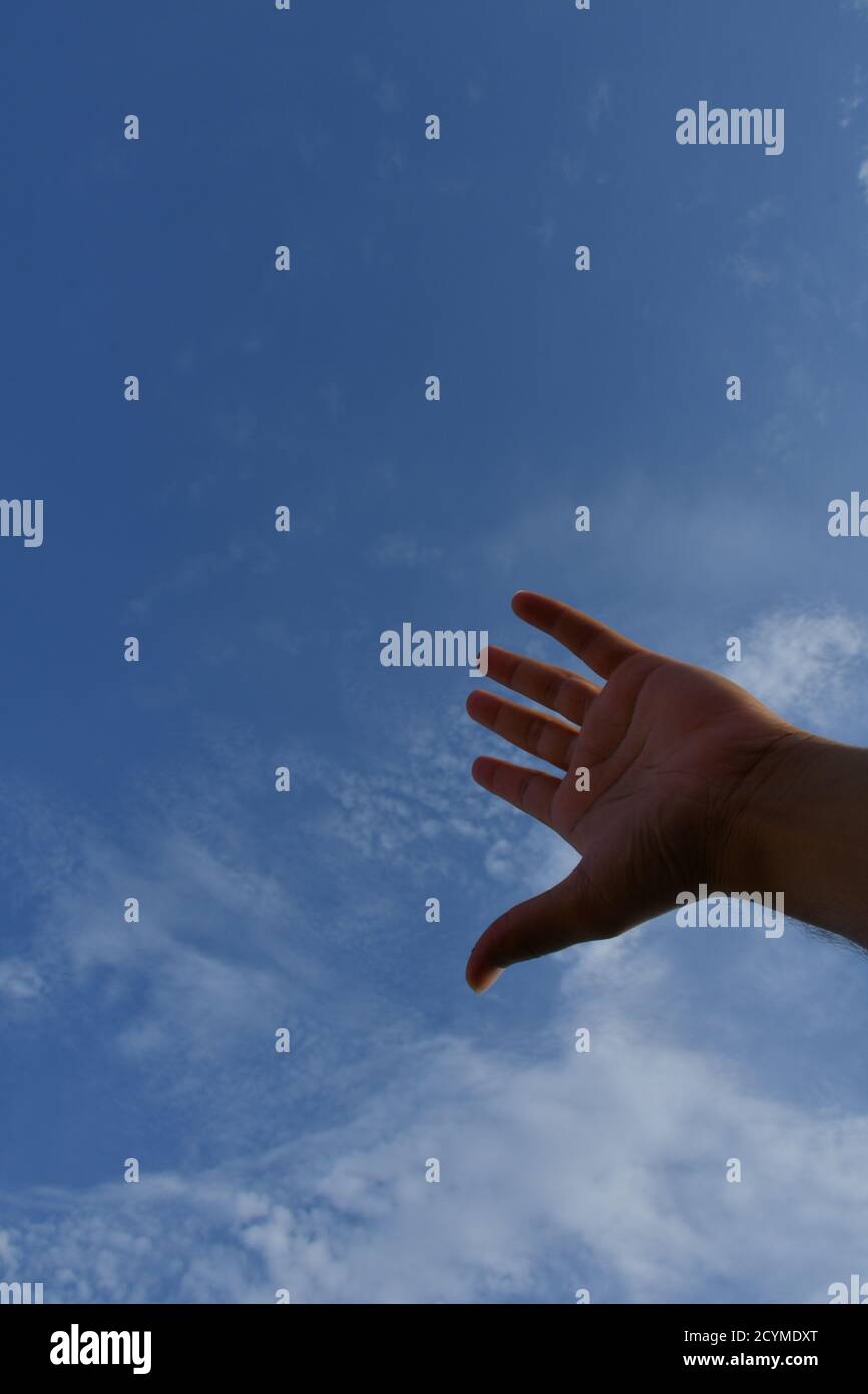Man Hand Position, try to Touching the sky Stock Photo - Alamy