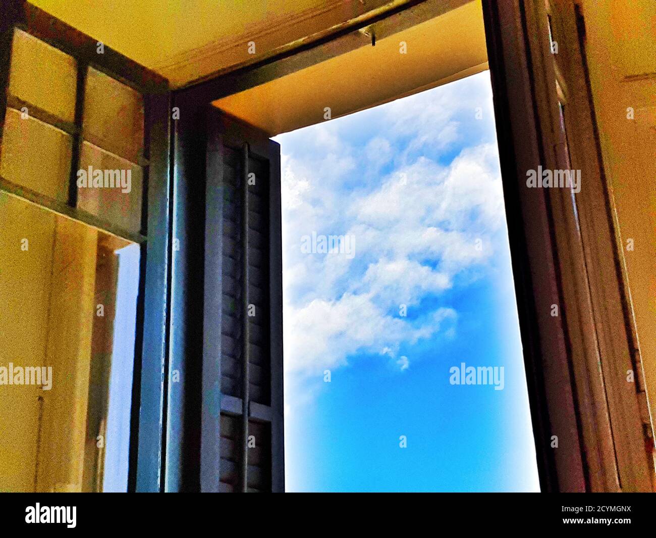 Opened windows, blue sky Stock Photo - Alamy