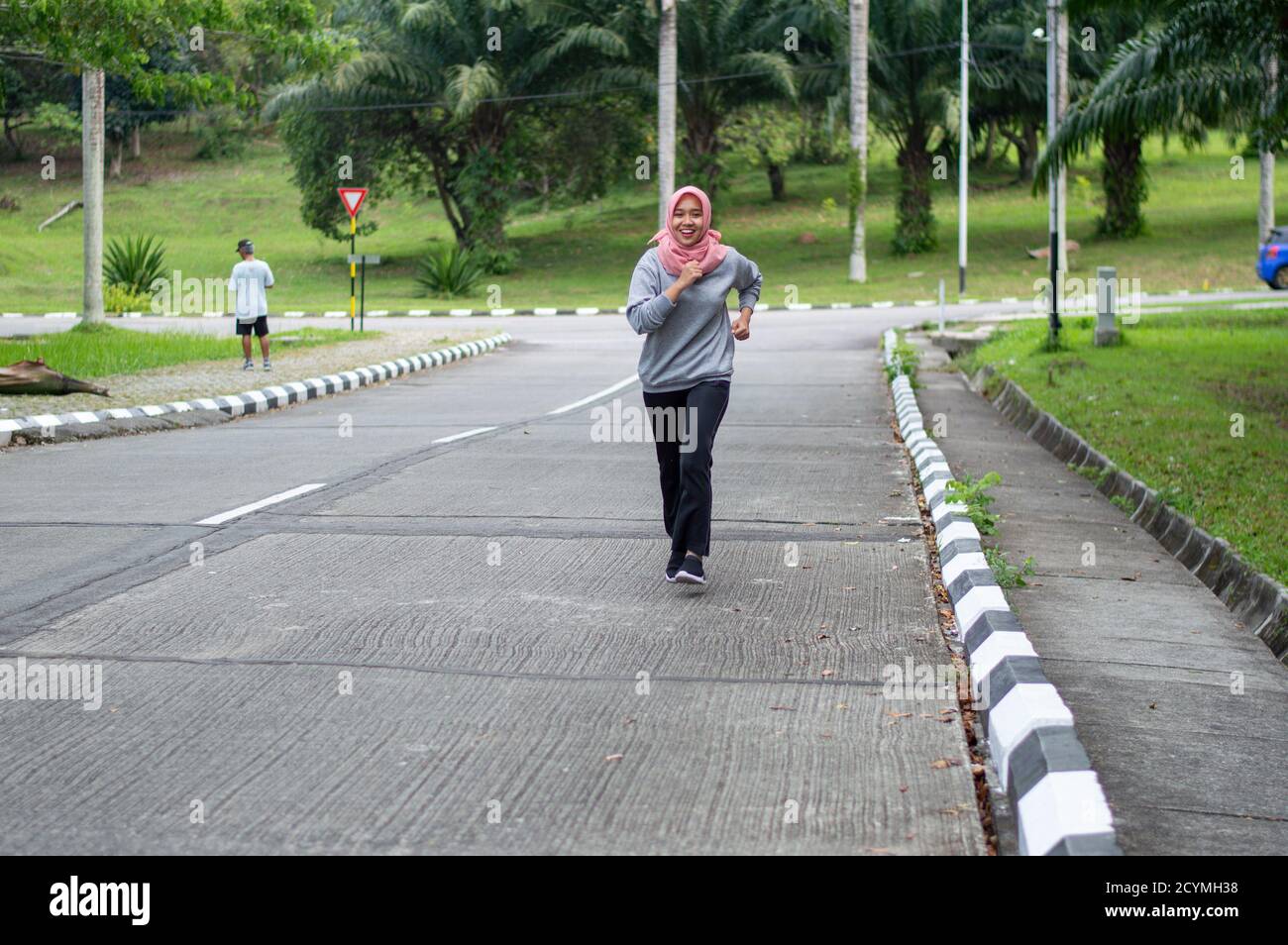 portrait of muslim young woman doing exercise and jogging outdoor at ...