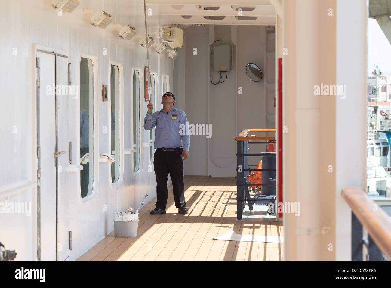 Filipino cruise ship worker painting and performing general maintenance ...