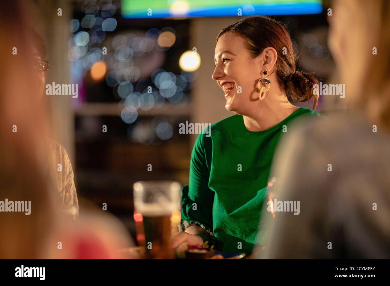 Group of friends drinking alcoholic drinks outdoors at a bar/restaurant ...