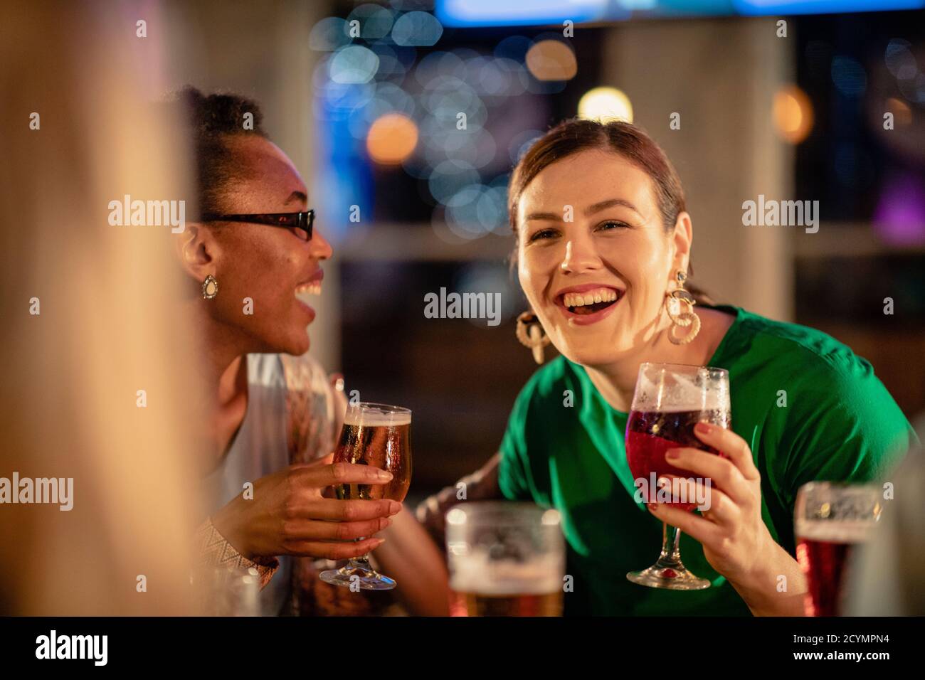 Group of friends drinking alcoholic drinks outdoors at a bar/restaurant ...