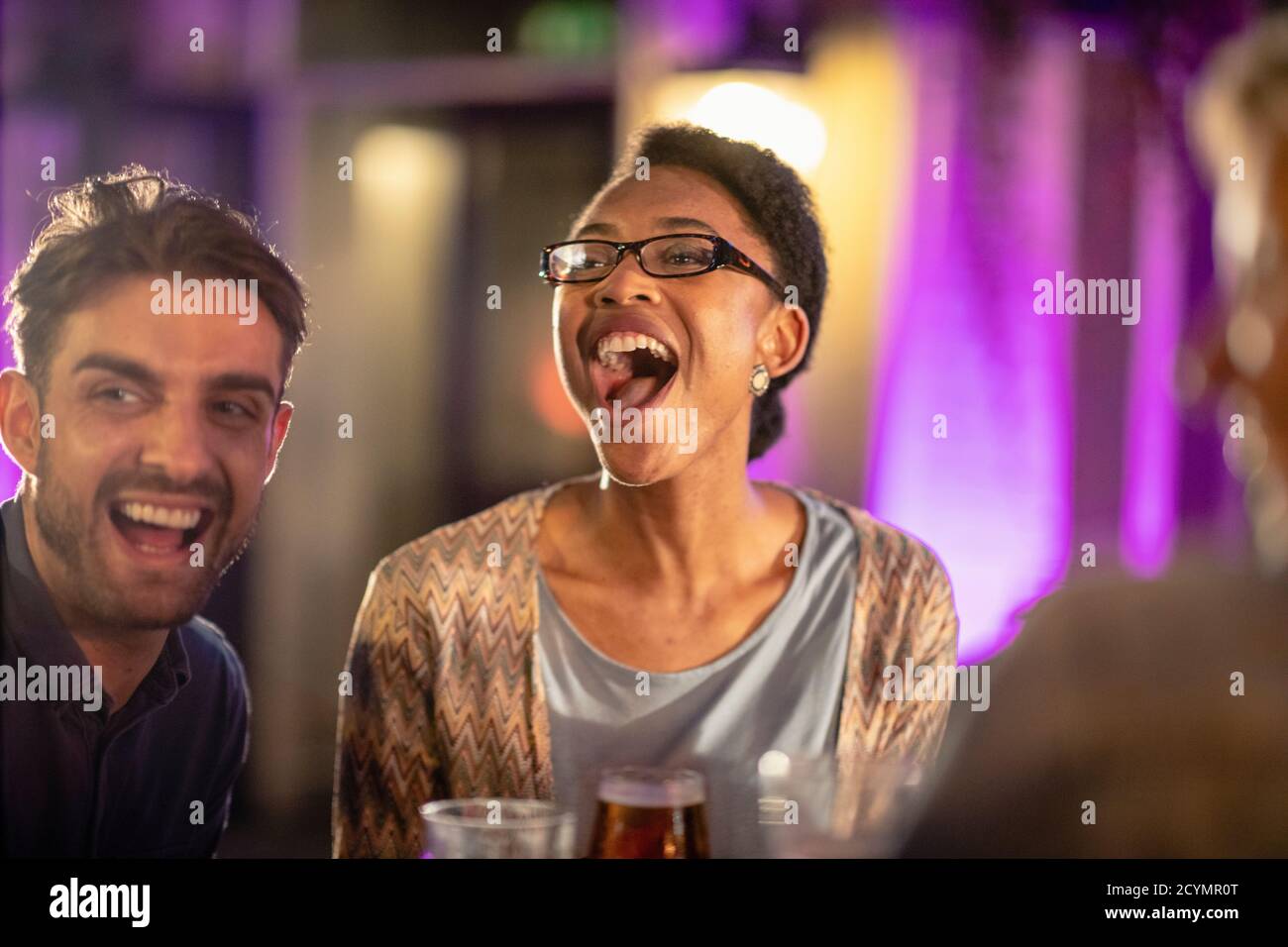 Group of friends drinking alcoholic drinks outdoors at a bar/restaurant ...