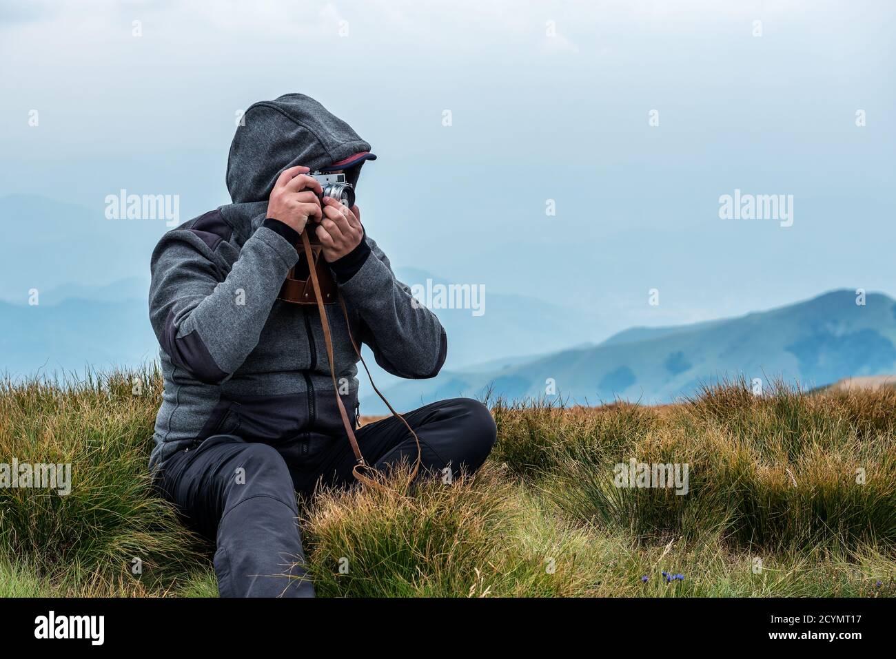 Photographer with old analog camera at a Mountain top. Mountain ...