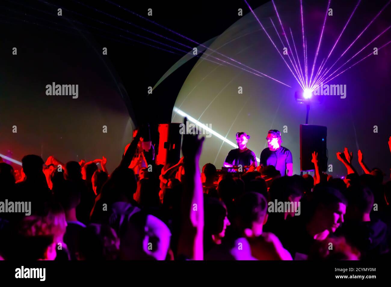 Crowd and DJs dancing during party Stock Photo - Alamy