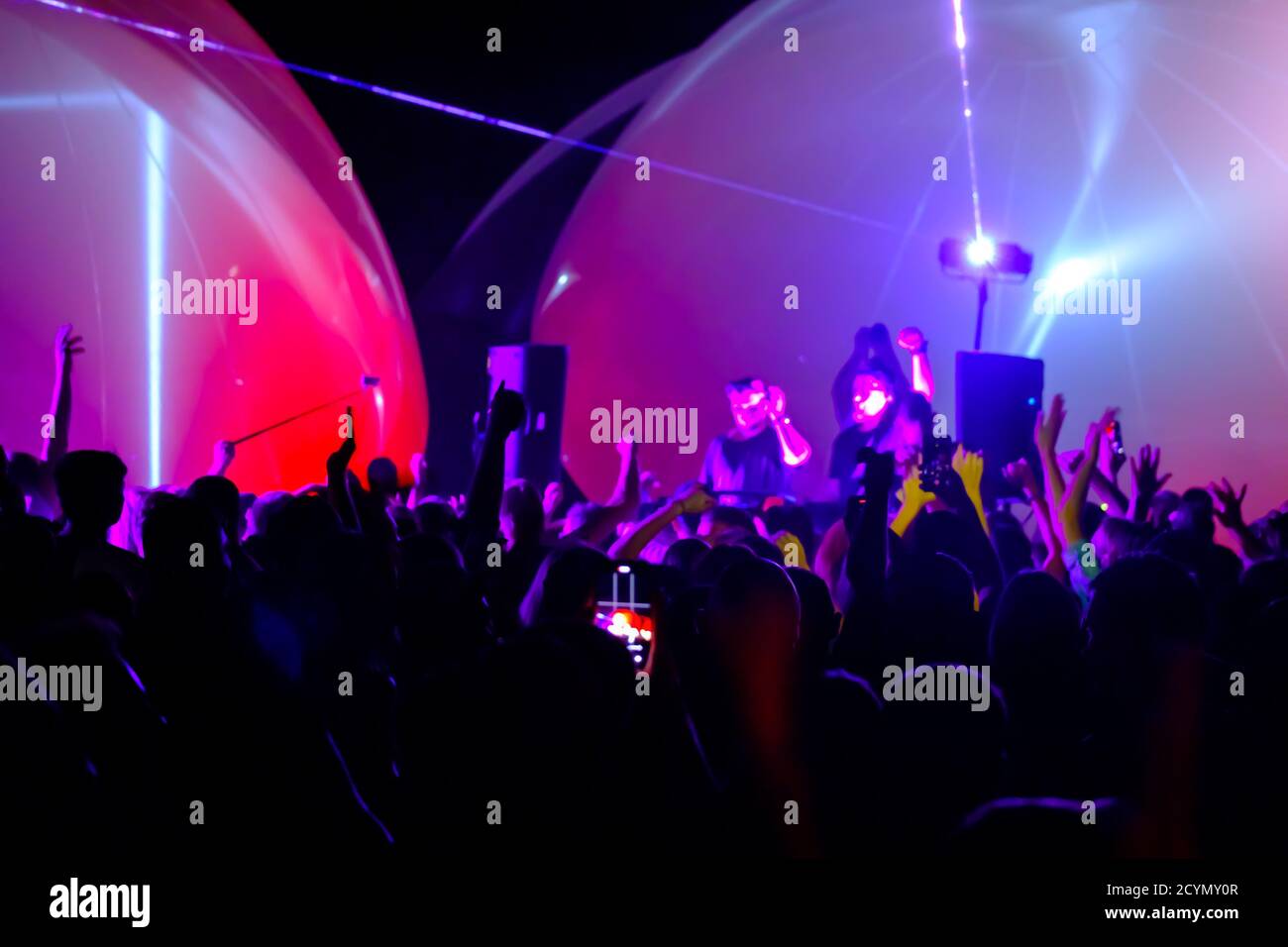 Crowd and DJs dancing during party Stock Photo - Alamy