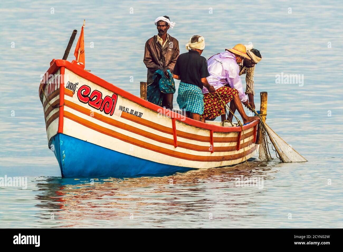 Fishermen retrieving net to their fishing boat on the Arabian Ocean ...