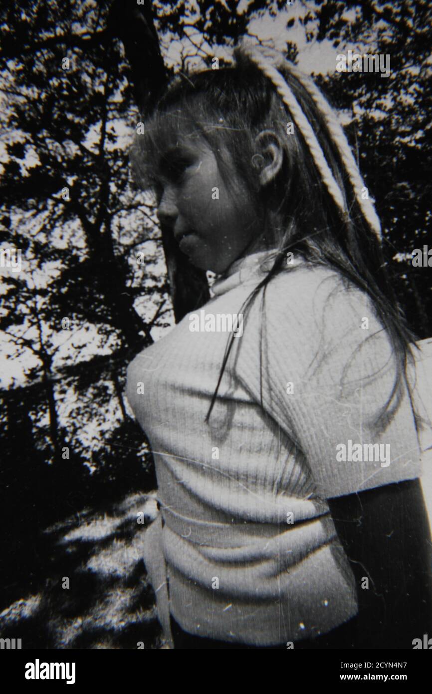 Fine 1970s vintage black and white photography of a young girl stuffing ...
