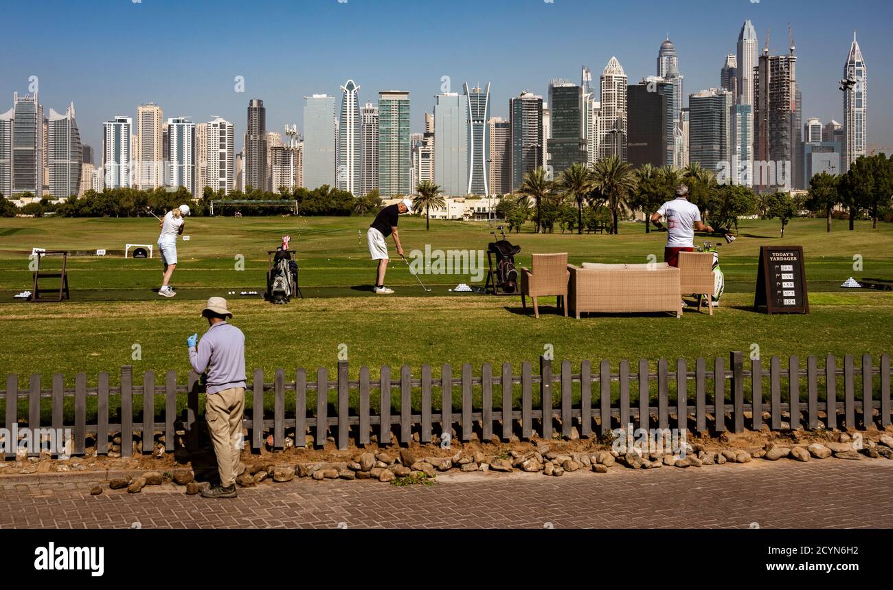 DUBAI, UAE, MAR 20, 2018: Golfers practice on driving range with Dubai ...