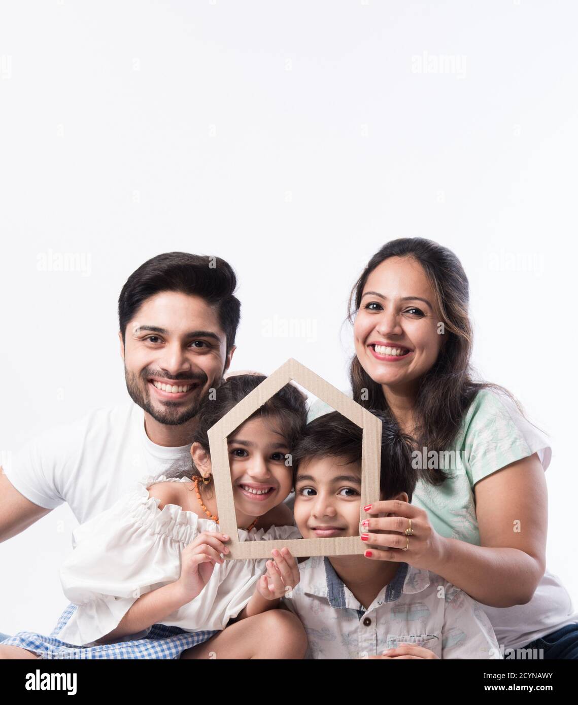 Indian family Father, mother, son and daughter holding 3D paper model ...