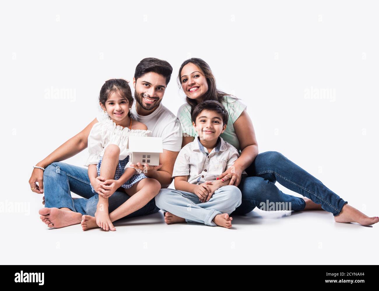 Indian family Father, mother, son and daughter holding 3D paper model ...