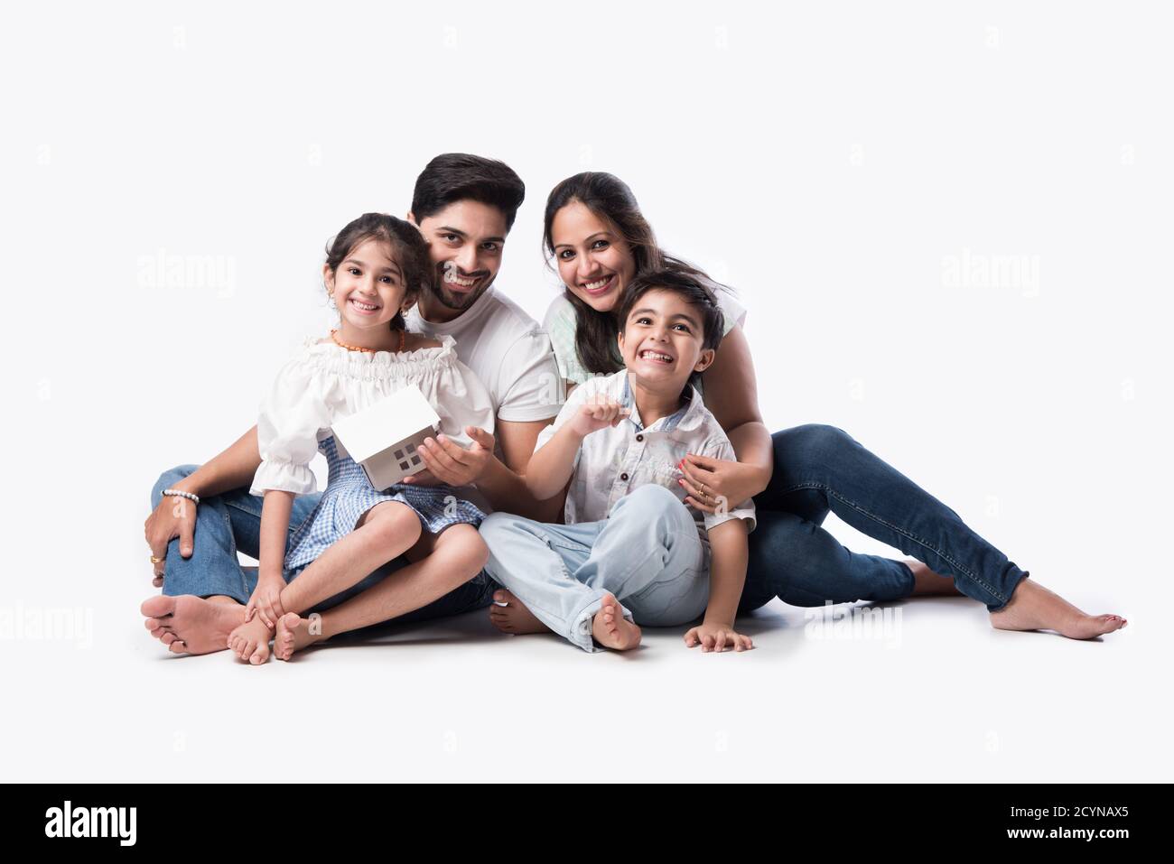 Indian family Father, mother, son and daughter holding 3D paper model ...