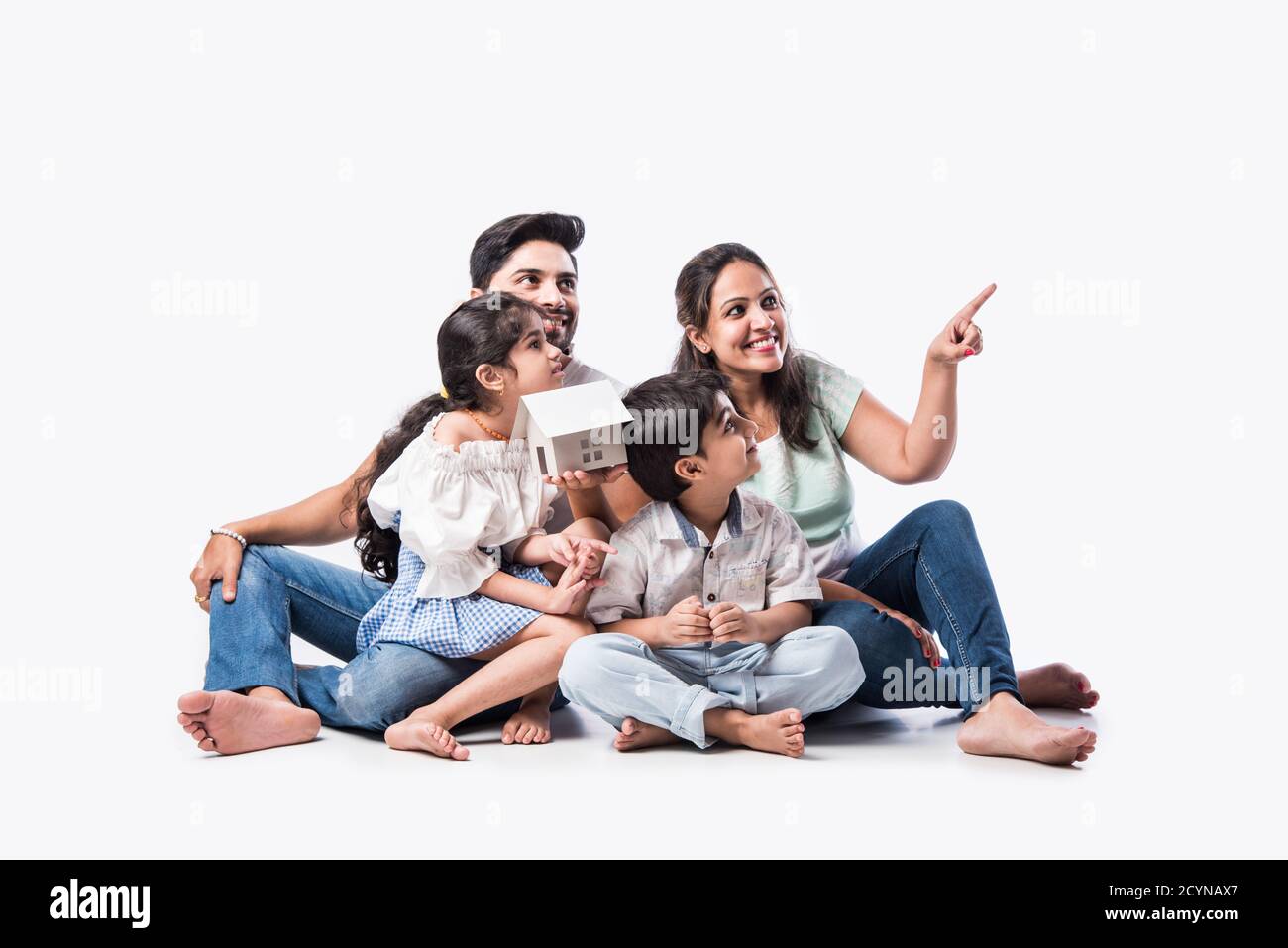 Indian family Father, mother, son and daughter holding 3D paper model ...