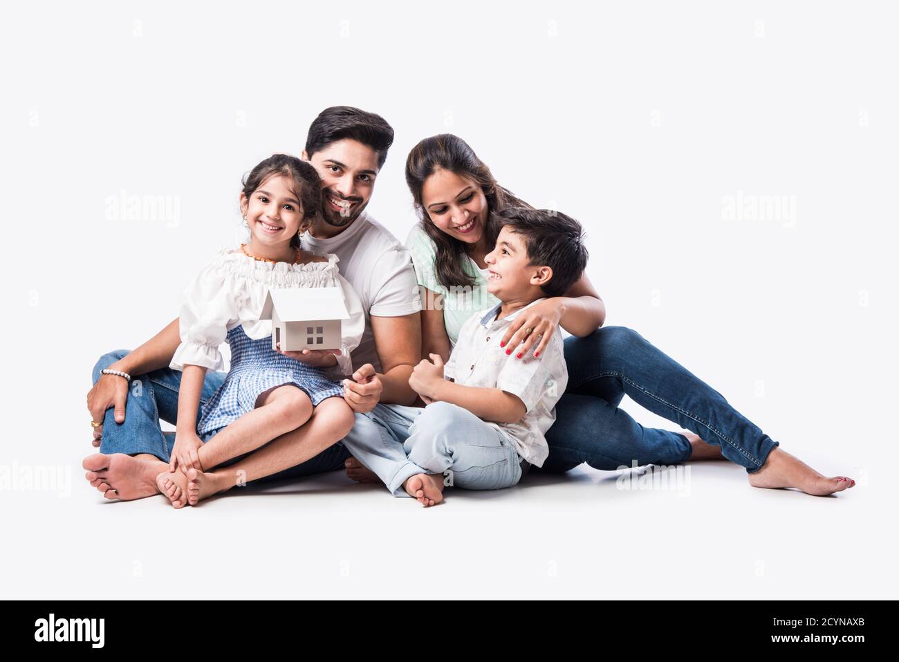 Indian family Father, mother, son and daughter holding 3D paper model ...