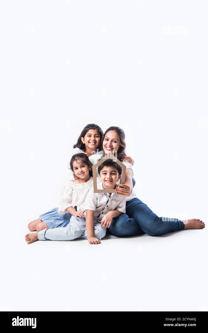 Indian family Father, mother, son and daughter holding 3D paper model ...