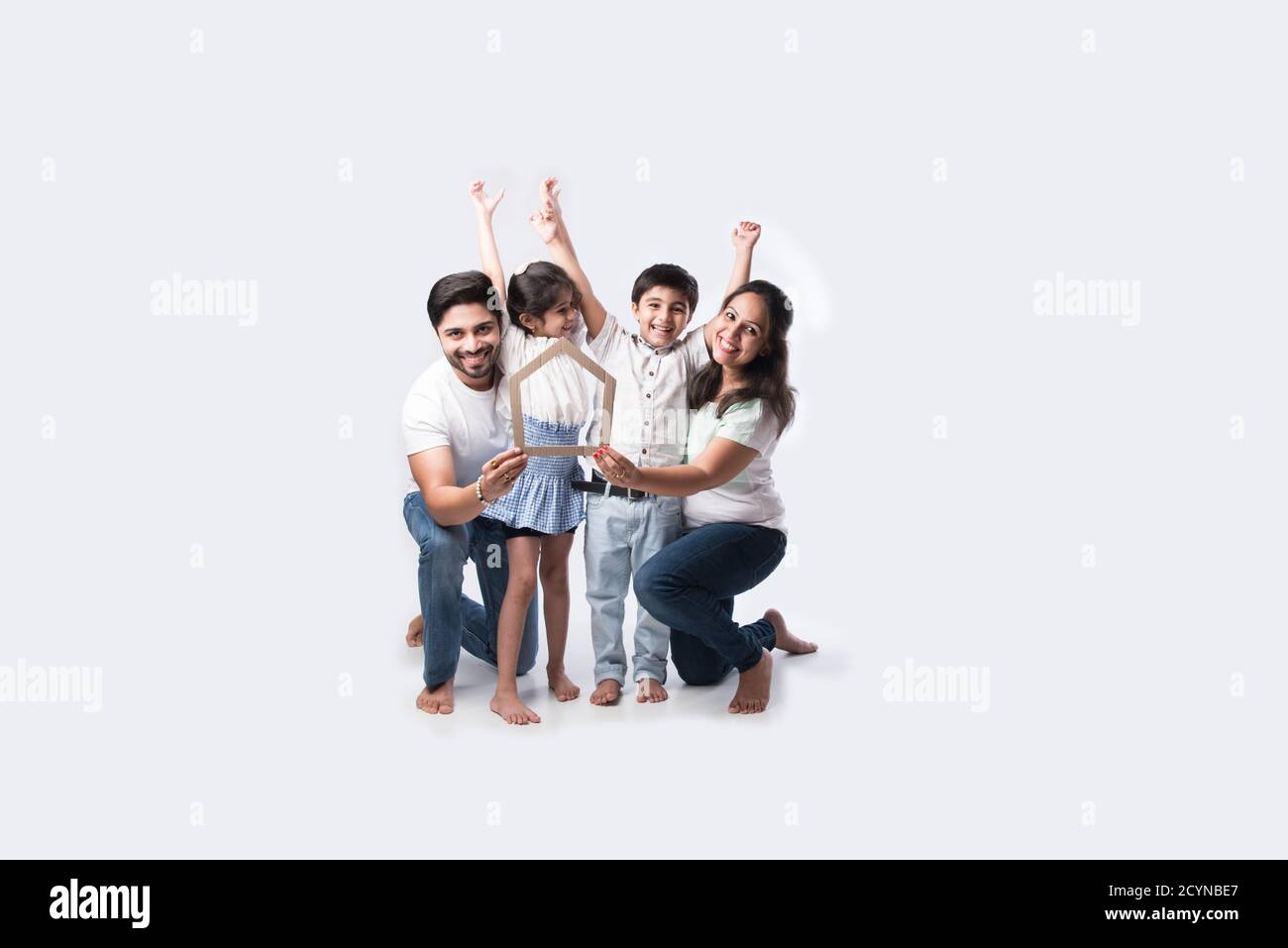 Indian family Father, mother, son and daughter holding 3D paper model ...