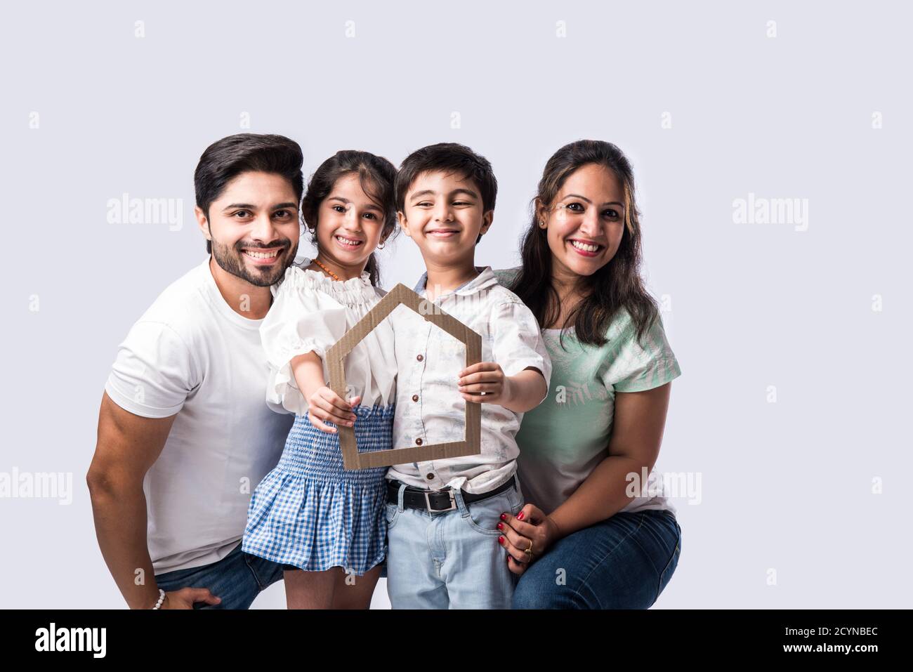 Indian family Father, mother, son and daughter holding 3D paper model ...