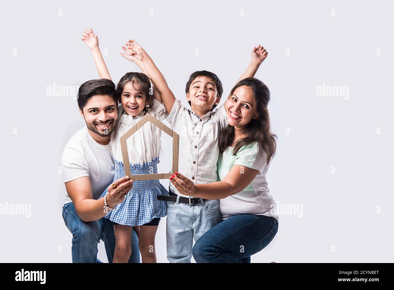 Indian family Father, mother, son and daughter holding 3D paper model ...