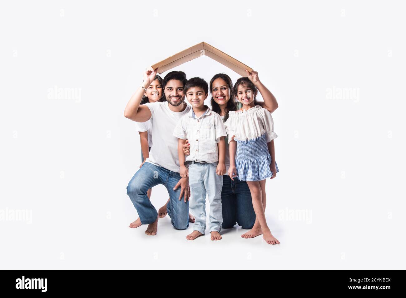 Indian family Father, mother, son and daughter holding 3D paper model ...