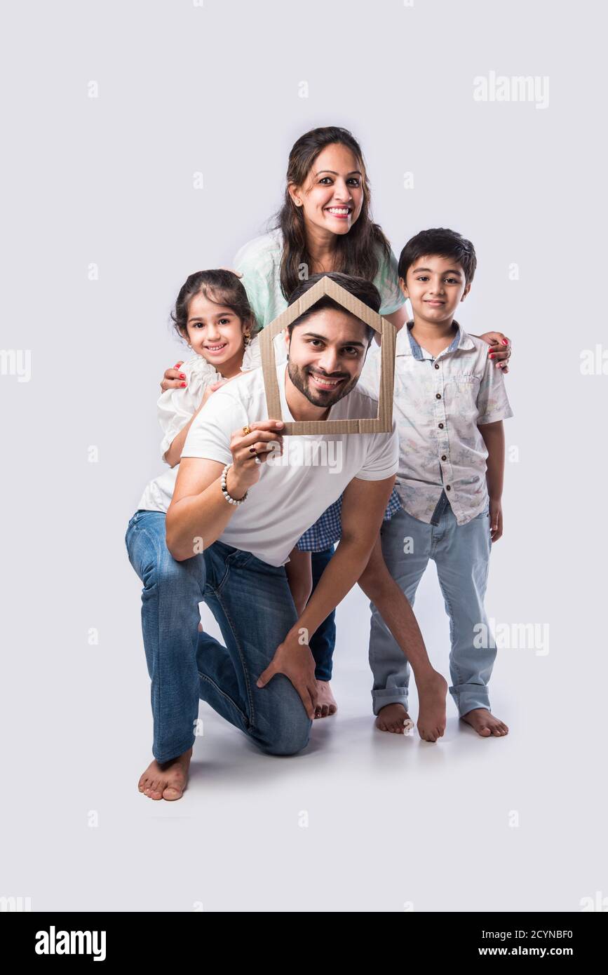 Indian family Father, mother, son and daughter holding 3D paper model ...