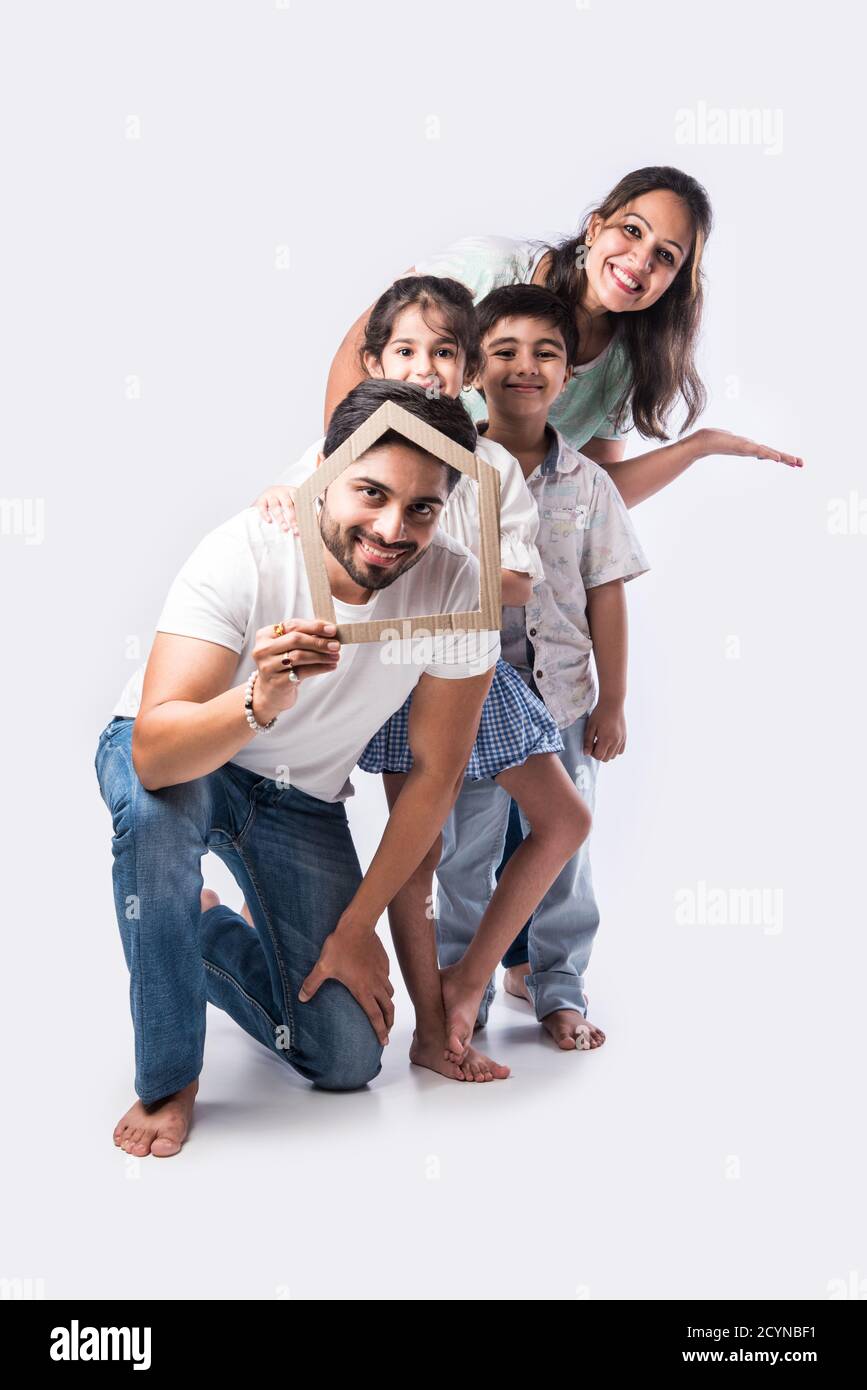 Indian family Father, mother, son and daughter holding 3D paper model ...