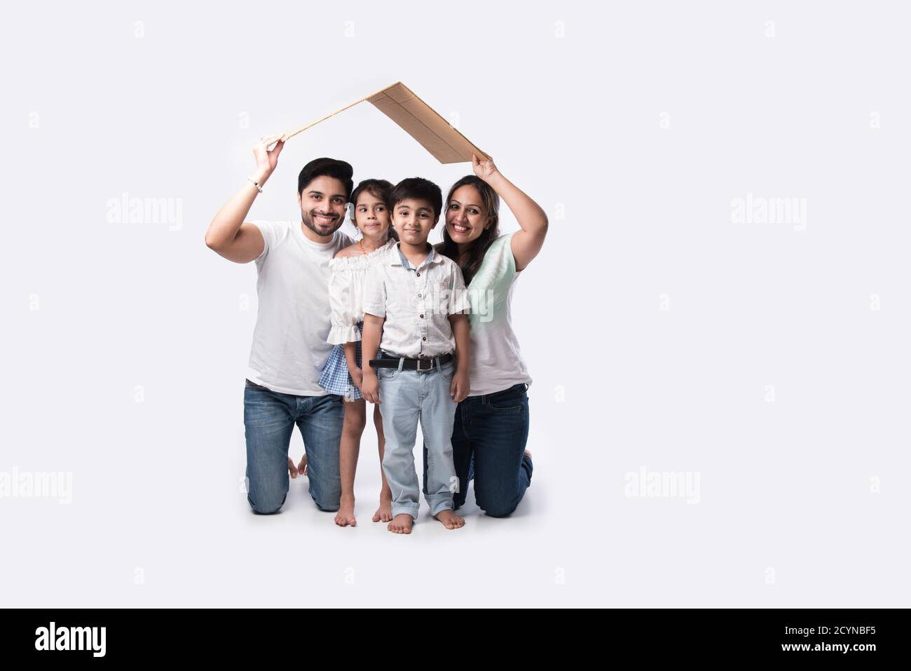 Indian family Father, mother, son and daughter holding 3D paper model ...