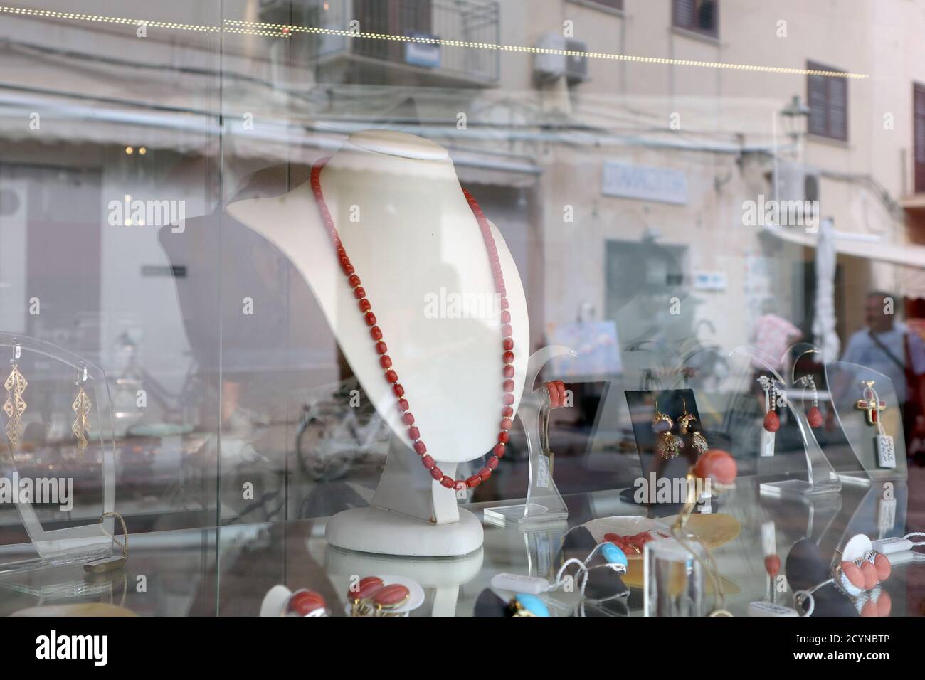 Jewellery shop window with reflection of street scene on island of ...
