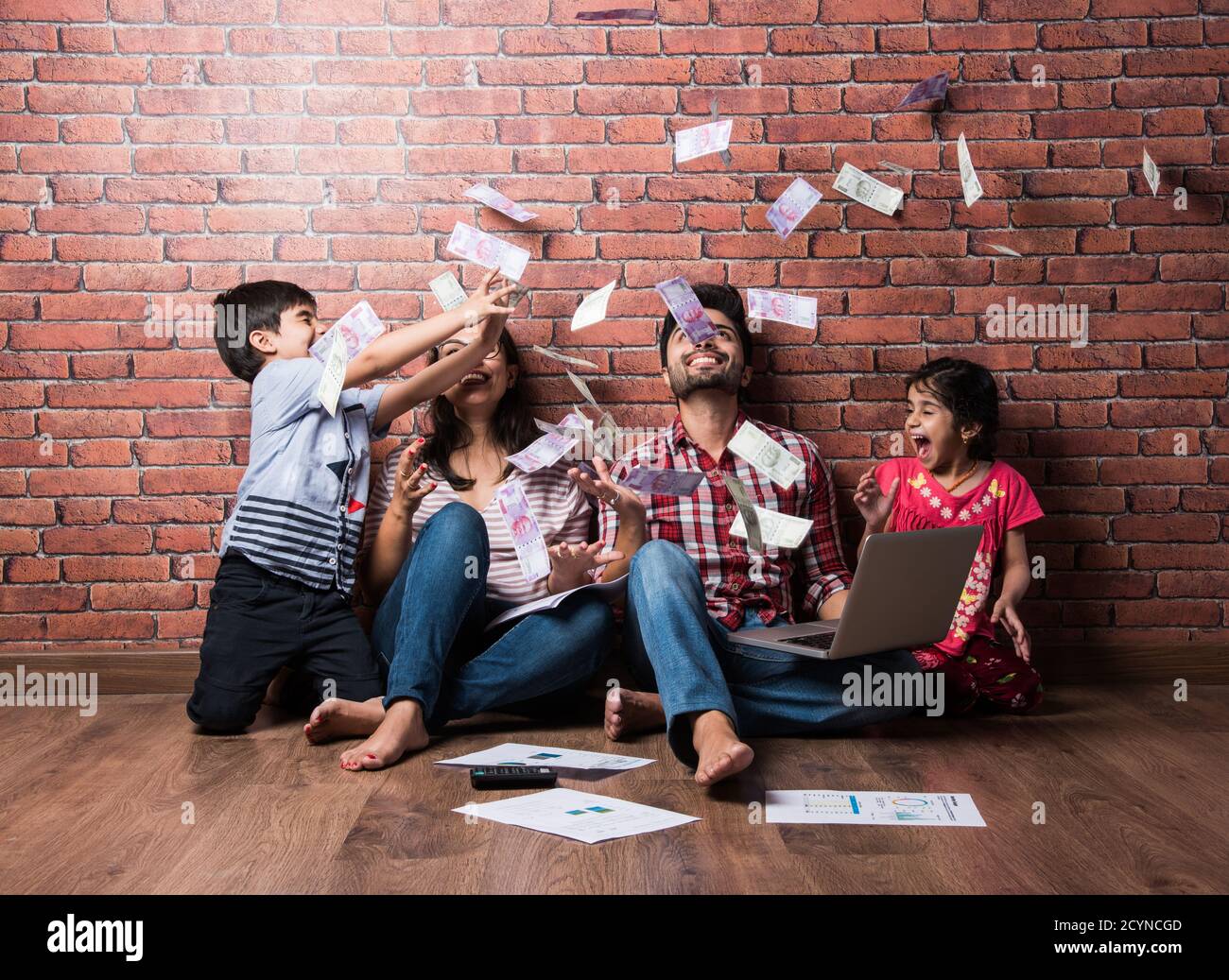 Indian family Father, mother, son and daughter holding 3D paper model ...