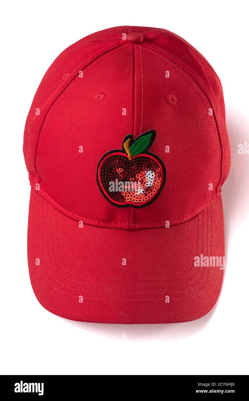 Red cap with sequin apple patch on white background Stock Photo - Alamy
