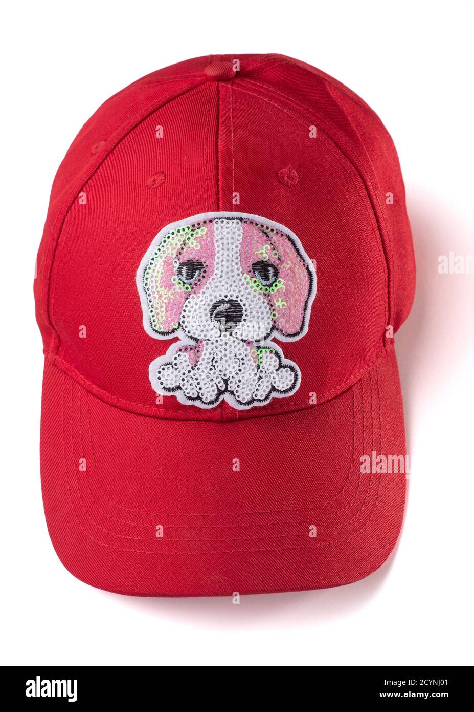 Red cap with a sequin dog patch on white background Stock Photo - Alamy