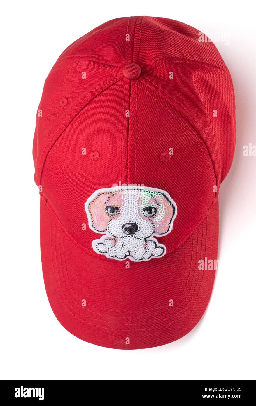 Red cap with a sequin dog patch on white background Stock Photo - Alamy