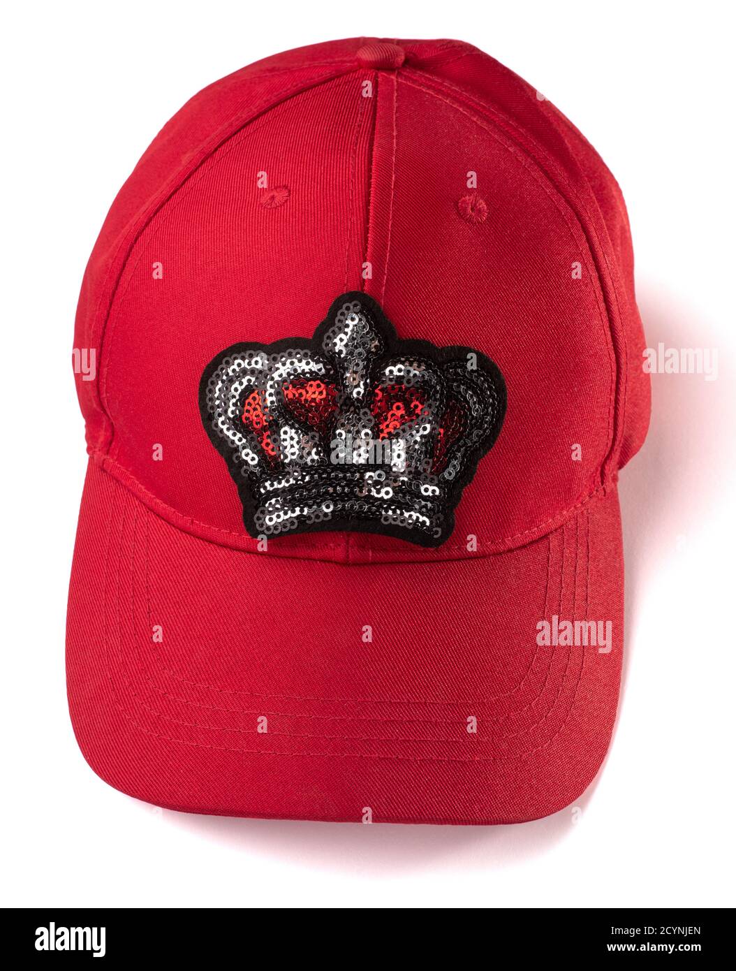 Red cap with a sequin crown patch on white background Stock Photo - Alamy