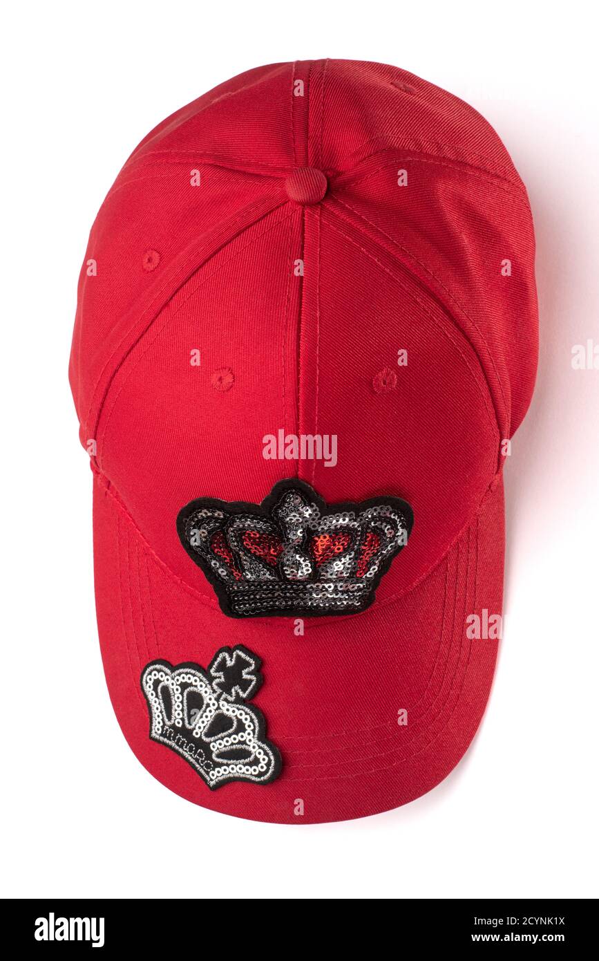 Red cap with sequin crown patches on white background Stock Photo - Alamy