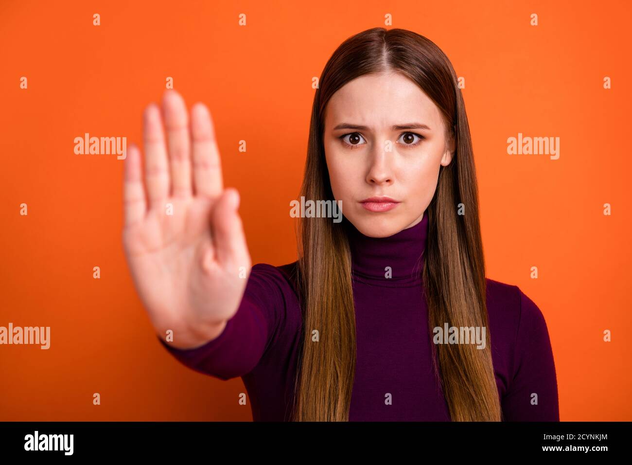 Stop dont move. Serious confident strict girl hold hand sign palm block ...