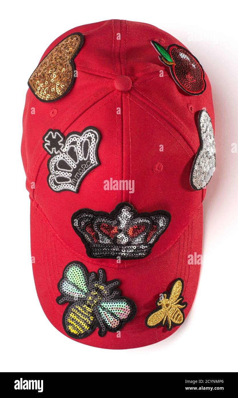 Basic red cap covered with various patches on white background Stock ...