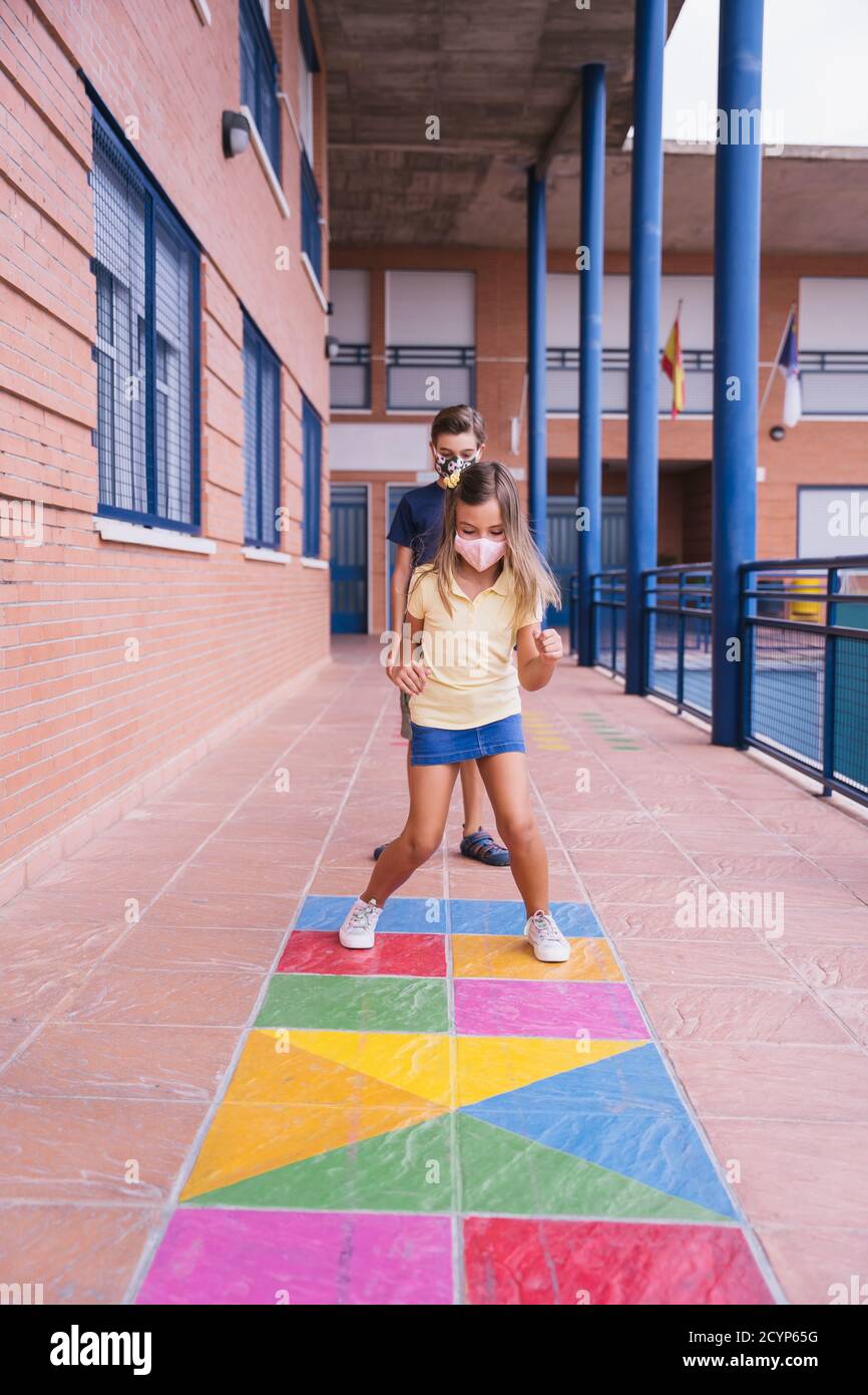 Back to school. Children running and jumping in the schoolyard with ...