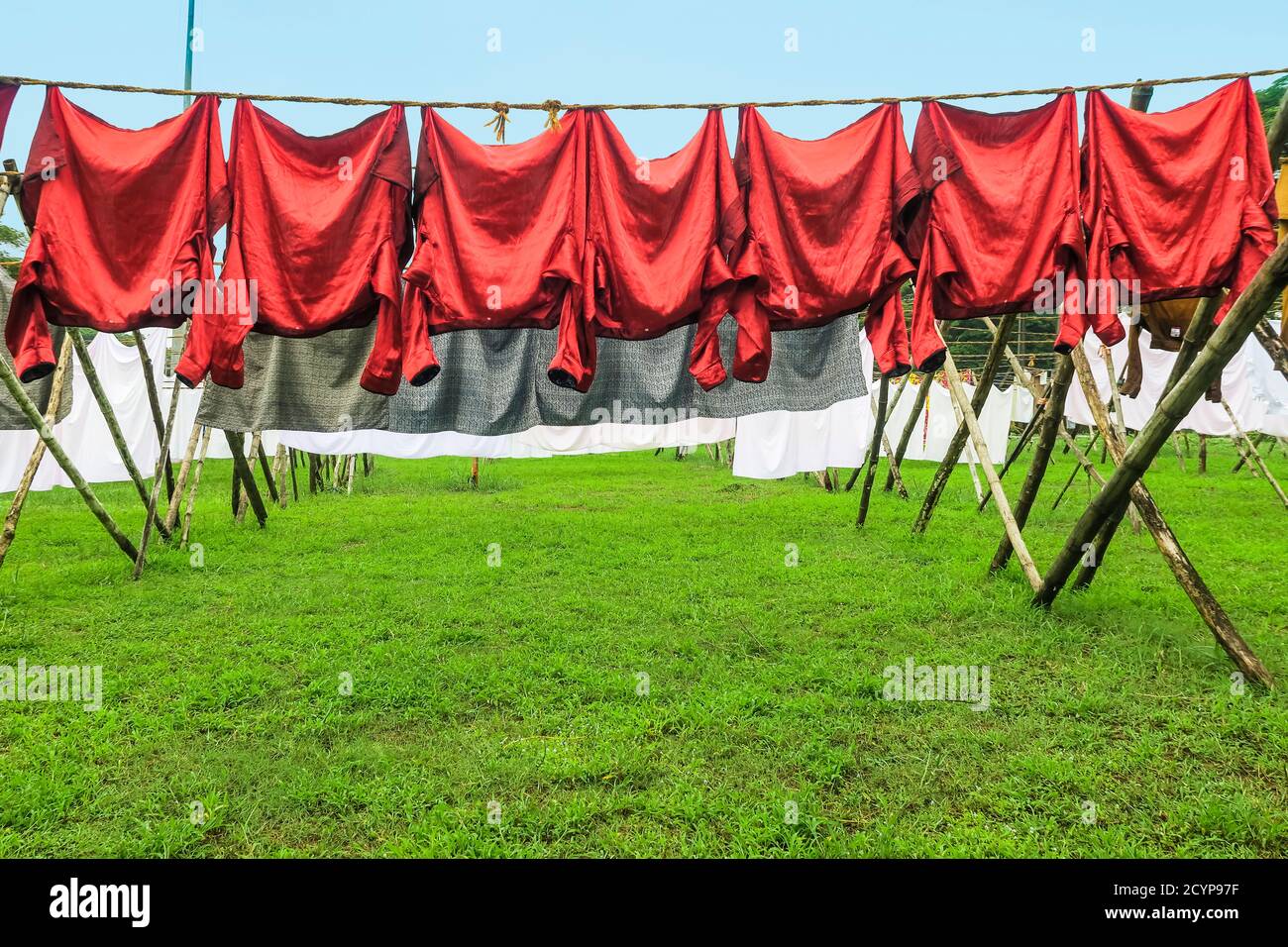 Red shirts drying in the sun on washing lines at the Dhobi Khana, a ...