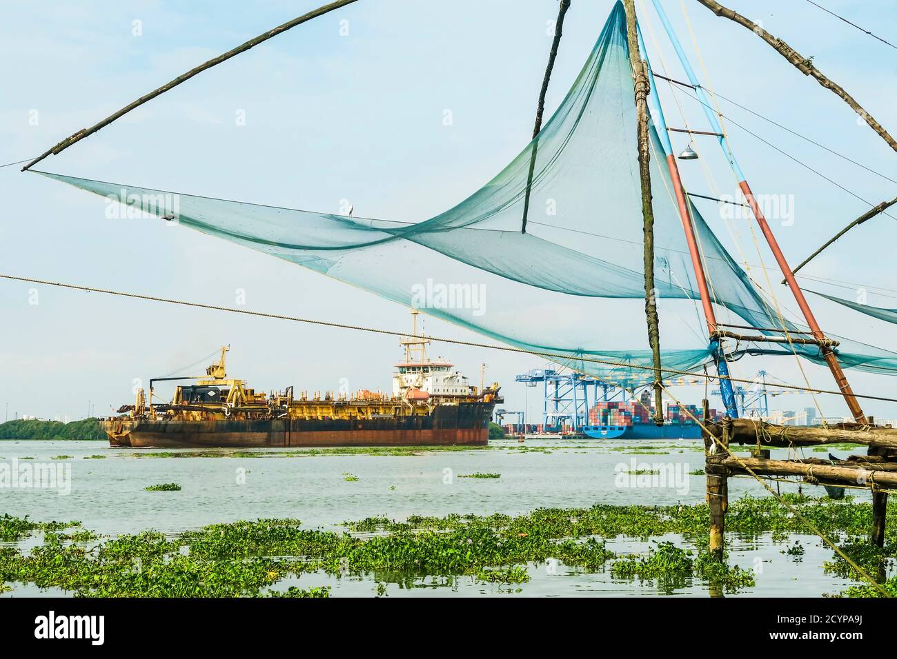 Traditional Chinese fishing net at Fort Cochin & dredger ship on ...