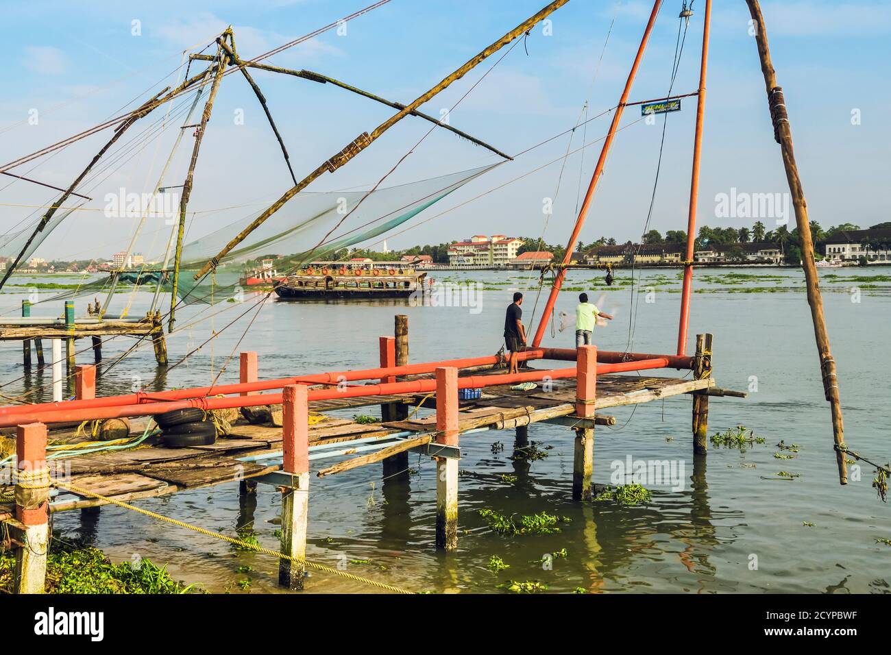 Old Chinese fishing nets, a tour boat & man casting net on the ...