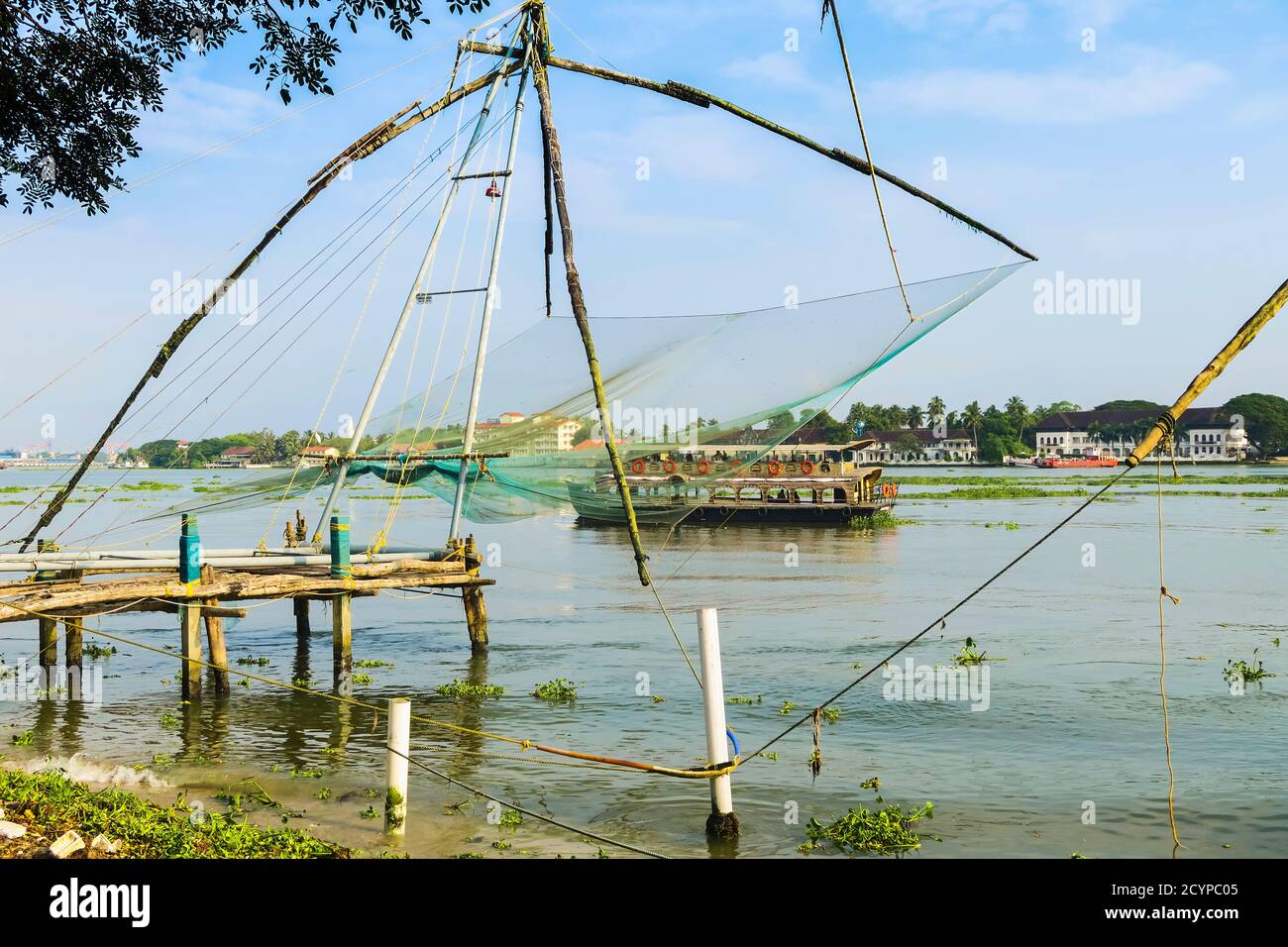 Old Chinese fishing nets & sight-seeing tour boat by the waterfront of ...