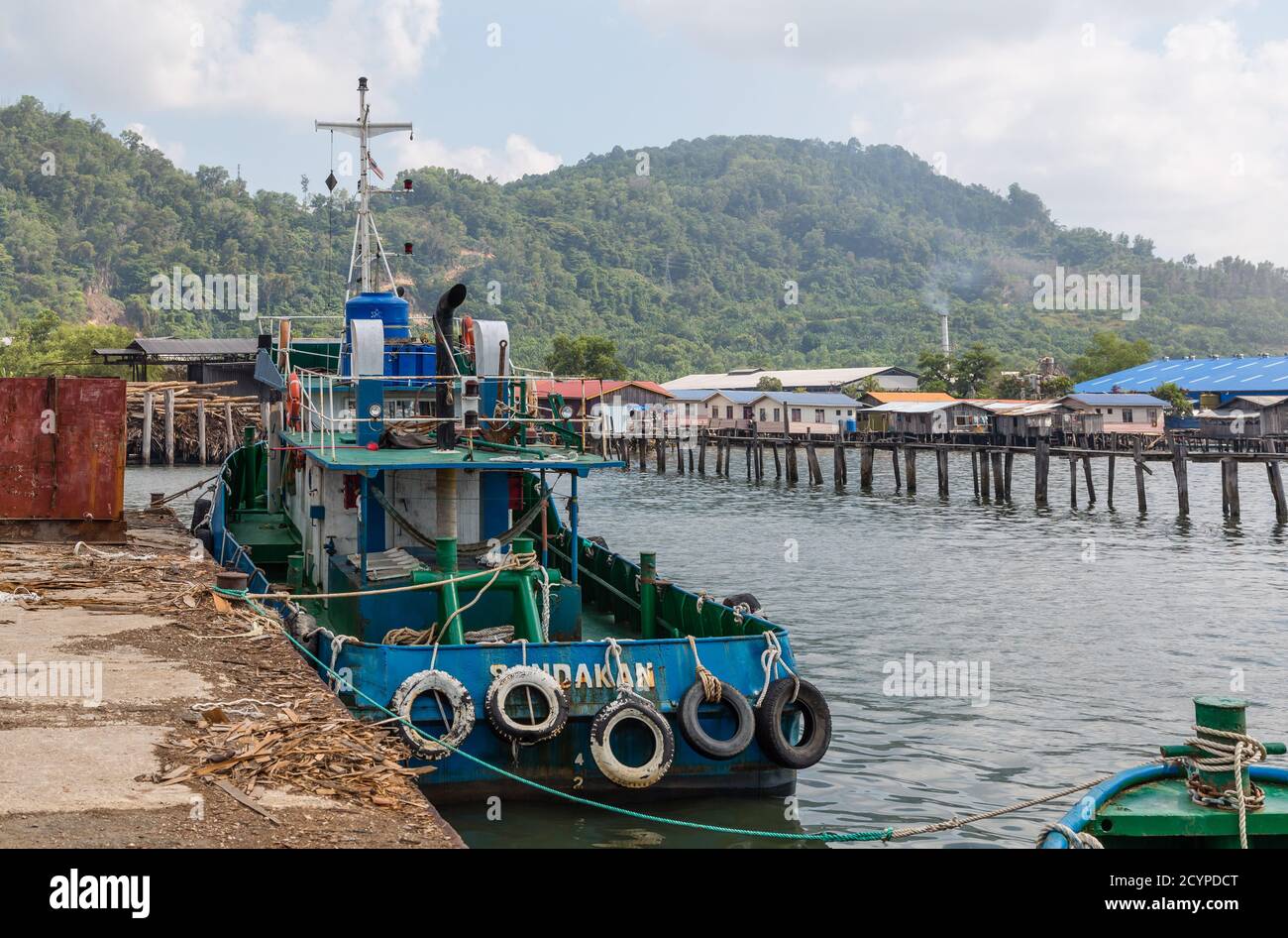 Tug boat at the delivery point of raw timbers, this boat is unsually ...