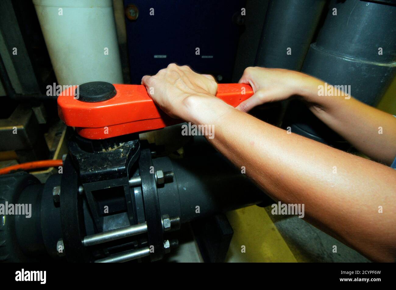 manual opening or closing a valve in an industrial plant Stock Photo ...